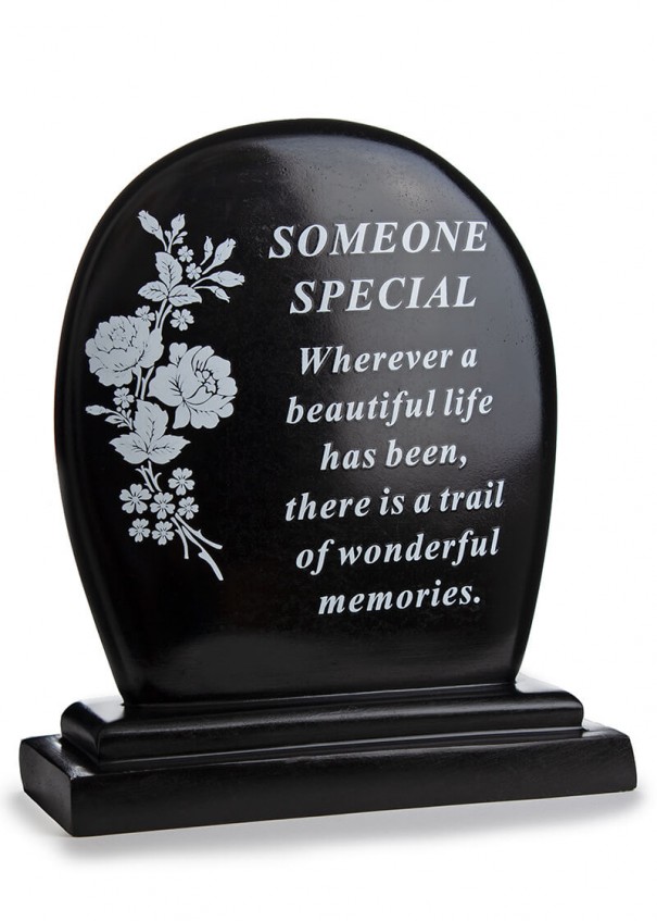 Rounded black graveside plaque with flower detail